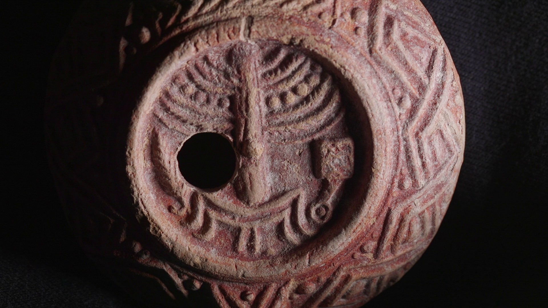 A rare 1,700-year-old oil candle, with the symbols of the temple on it - a menorah, a torch and ...